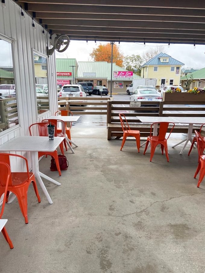 The covered patio with bright orange chairs offers al fresco dining without the sunburn—seafood with a side of people-watching and coastal breezes.