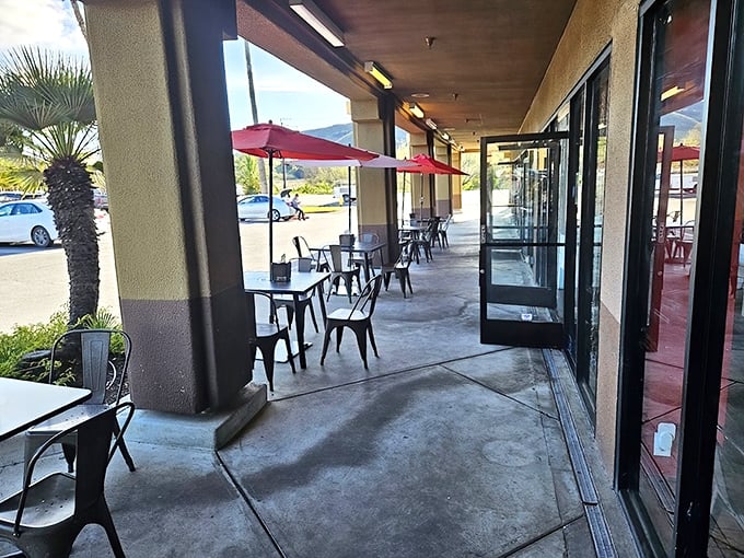 The outdoor seating where sauce-stained fingers are a badge of honor. Those red umbrellas aren't just for shade—they're warning signals for the flavor explosion ahead.