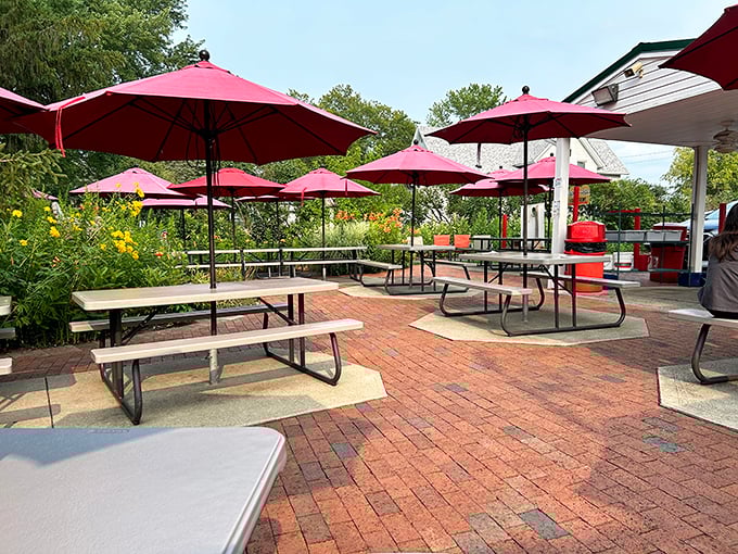 The outdoor dining area, with its cheerful red umbrellas and picnic tables, invites you to savor summer one bite at a time in this corner of Ohio paradise.