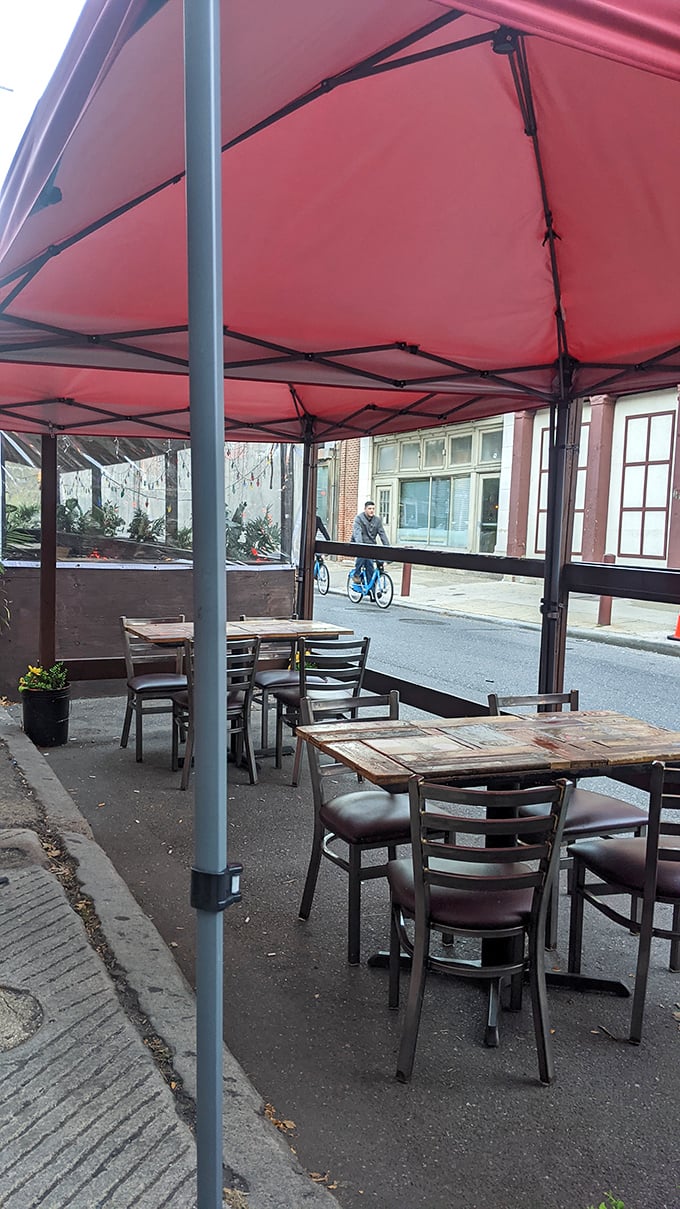 Outdoor seating under a simple red canopy – because sometimes a sandwich this good deserves fresh air and people-watching opportunities.