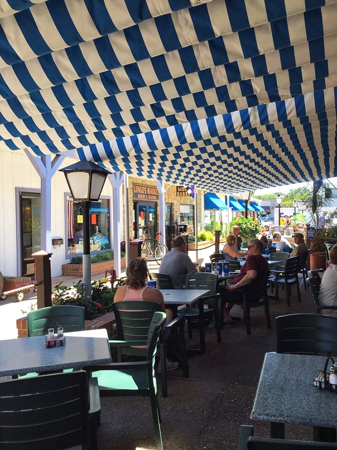 The outdoor seating area, with its blue and white canopy, turns lunch into a mini-vacation—even if you're just on your lunch break.