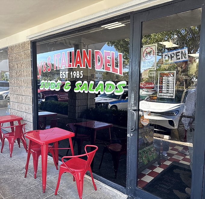 Those cheerful red tables outside aren't just furniture—they're front-row seats to the simple pleasure of enjoying a perfect sandwich under Florida skies.