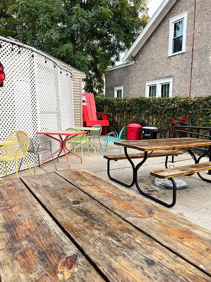Weather-worn picnic tables tell stories of countless summer meals. This outdoor seating area has witnessed generations of burger-induced happiness.