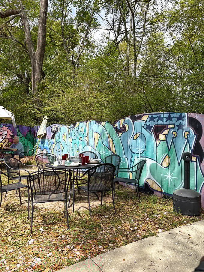 The secret garden of Woodchuck's – where outdoor tables nestled against street art create an unexpected urban oasis for alfresco dining.