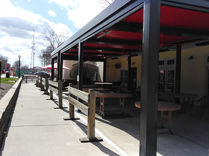 Red-roofed outdoor seating where the only thing better than the fresh air is the aroma of grilled perfection wafting from inside.