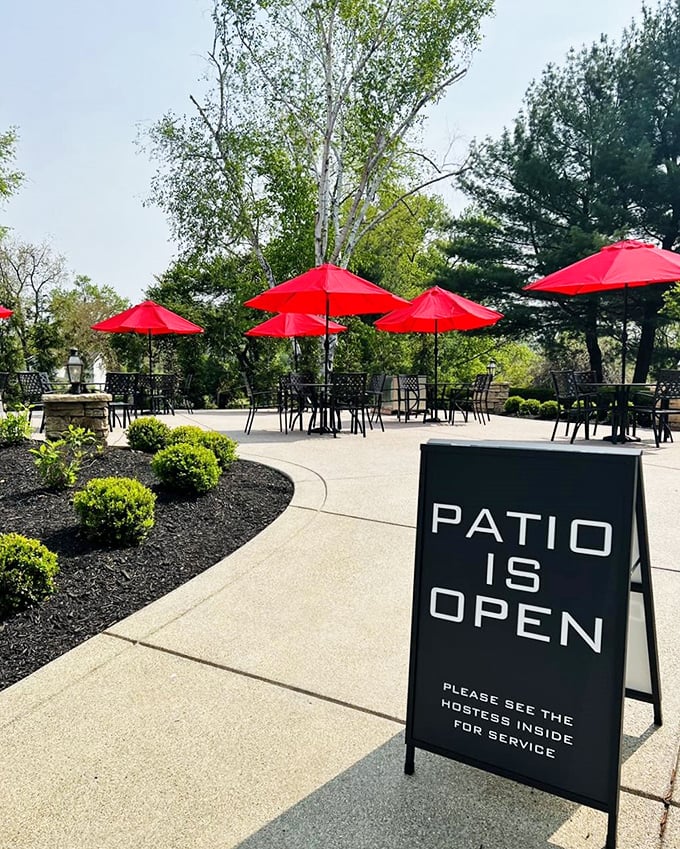 Red umbrellas stand at attention like culinary guardians, protecting outdoor diners from everything except the temptation of ordering dessert.