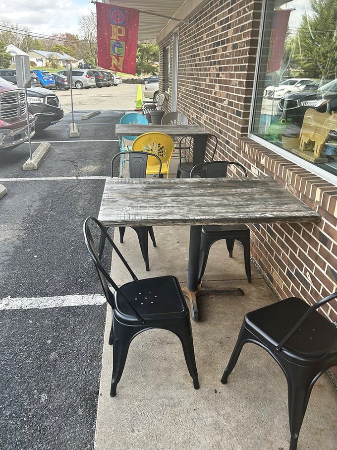 Even the outdoor seating says "stay awhile"—rustic tables and industrial chairs creating a perfect perch for people-watching between bites of breakfast bliss.