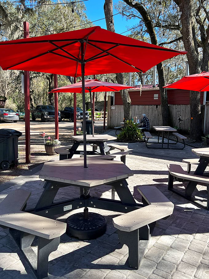 Red umbrellas provide shade while you contemplate the meaning of life, or more likely, whether you have room for another helping of brisket.
