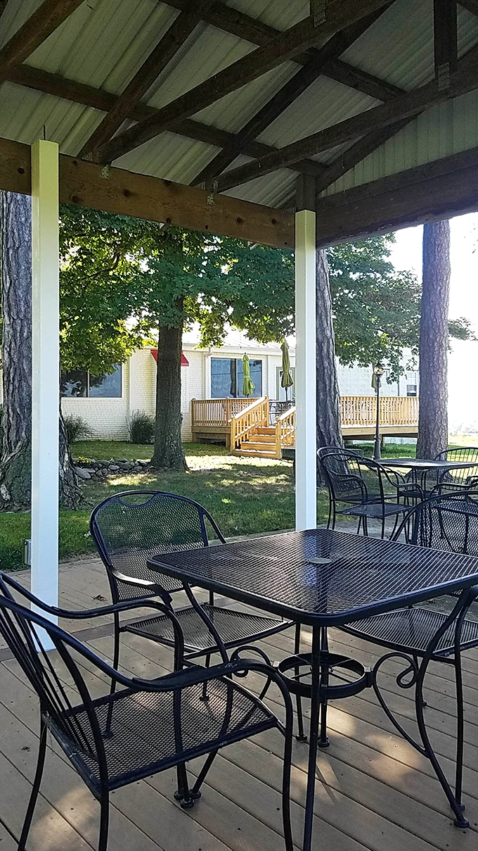 The covered patio offers a shaded retreat where you can enjoy your meal while gazing at the grounds – al fresco dining with a side of serenity.