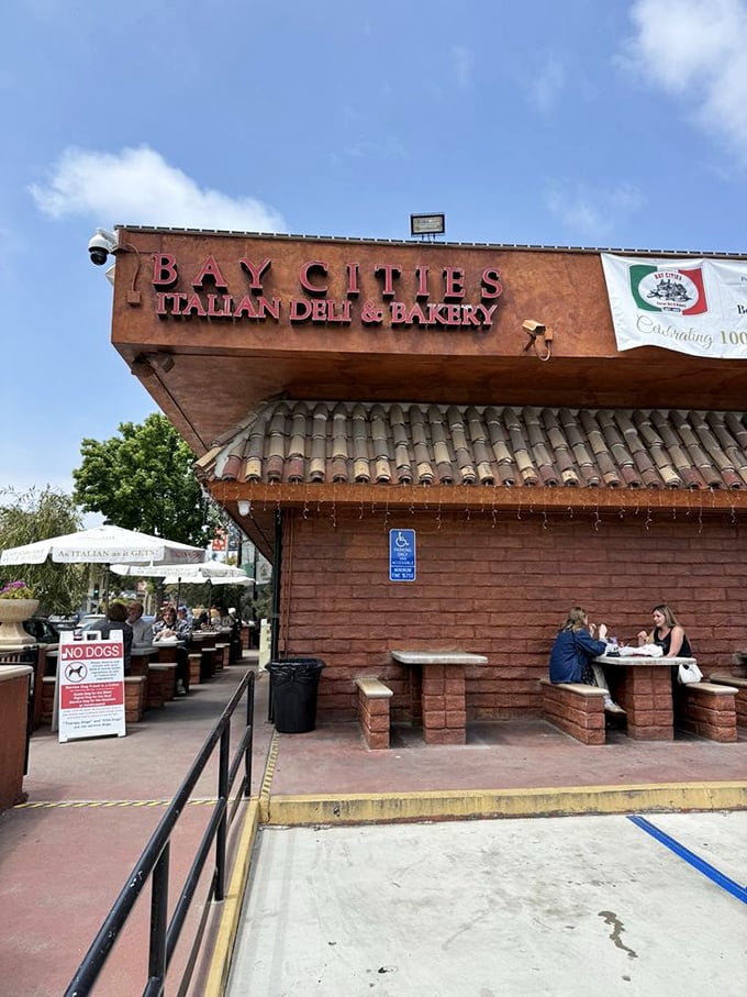 The outdoor seating area—simple brick tables where magic happens. Where strangers bond over the shared experience of sandwich bliss.
