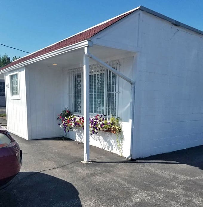 Even the exterior gets a touch of charm with flower boxes brightening the simple white building—a hint at the warmth waiting inside.