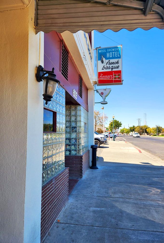 The vintage sign promises "French Basque dinners" – three words that have caused countless detours and never once disappointed a hungry traveler.