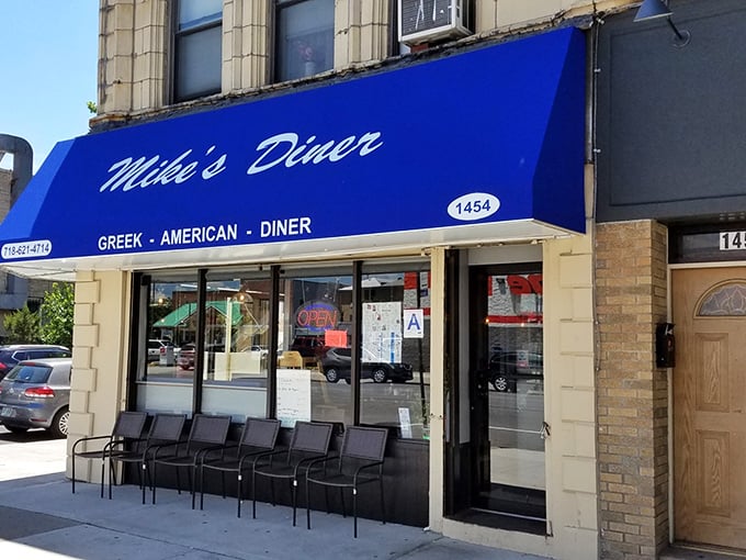 That blue awning isn't just a sign—it's a promise that inside this corner of Brooklyn, breakfast dreams come true seven days a week.