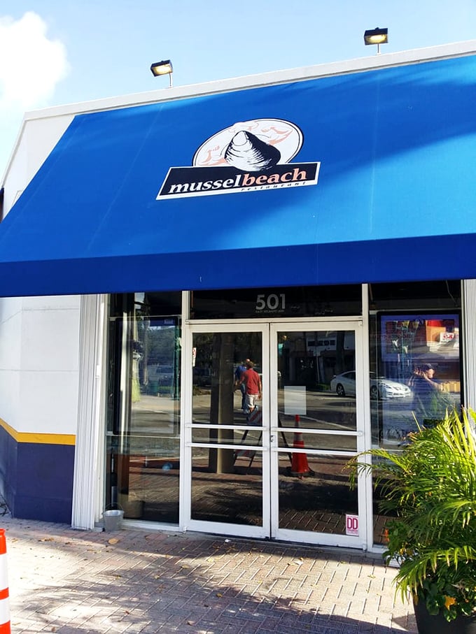 The entrance says it all – this isn't just a restaurant, it's a destination. That blue awning is basically Florida's seafood bat signal.