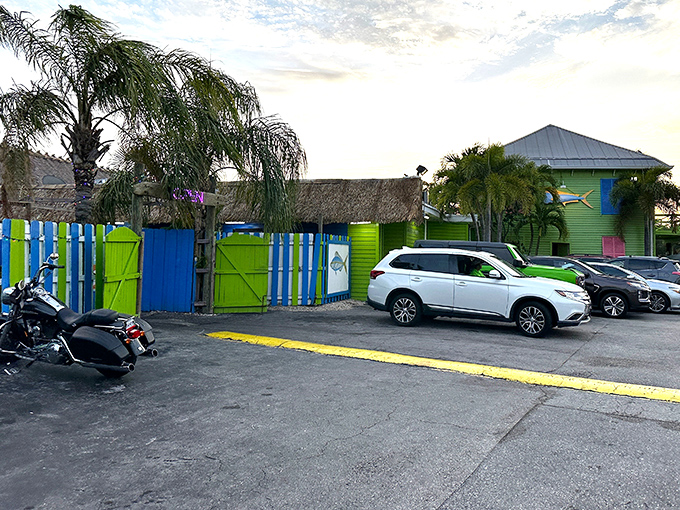Even the parking lot continues the tropical color scheme. The lime green and blue fence promises the vacation vibes start before you even enter.
