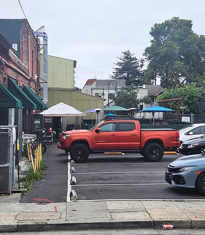 The back parking area reveals the restaurant's humble exterior—proof that culinary treasures often hide in the most unassuming packages.