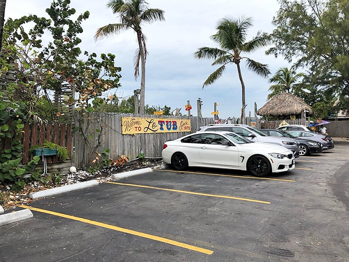 The parking lot might be the only ordinary thing about Le Tub—but even it has palm trees, a thatched hut, and the promise of extraordinary flavors waiting inside.