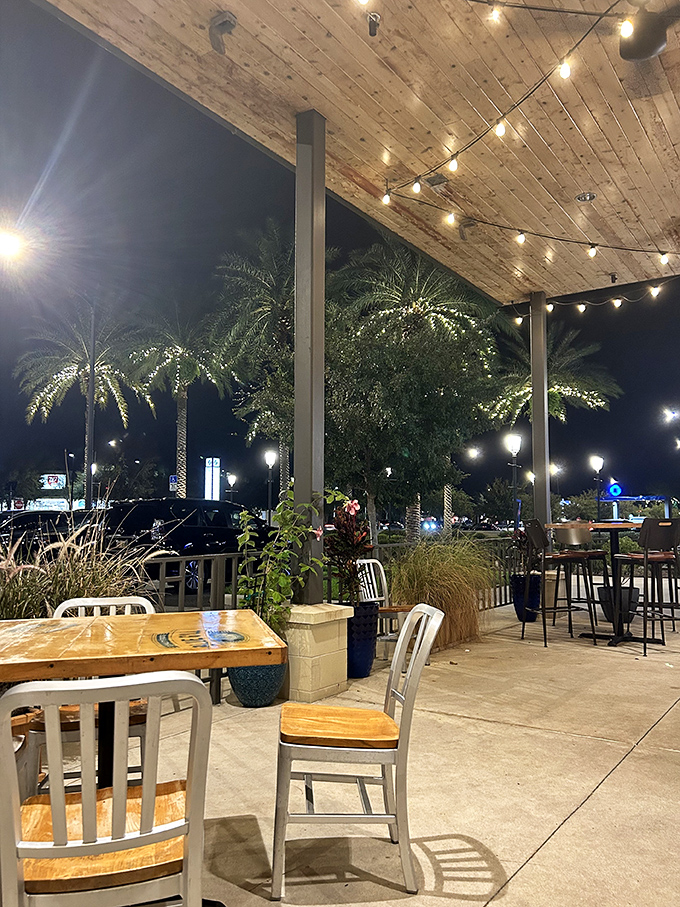 The outdoor patio, where string lights twinkle above and palm trees sway—dinner and a Florida light show all in one magical setting.