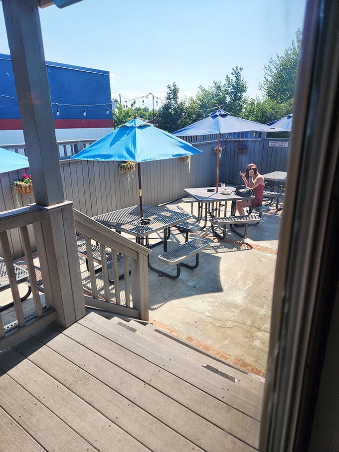 The outdoor patio—where summer afternoons stretch into evenings, and strangers become friends over shared plates and cold drinks.