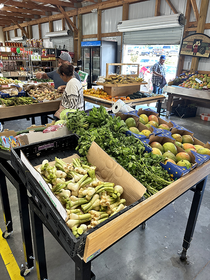 Farm-to-flea-market produce displays offer locally grown vegetables alongside fruits that traveled farther than some of the market's weekend visitors.