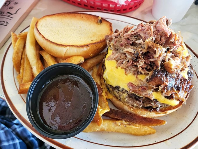 This isn't just a pulled pork sandwich—it's architecture. The golden fries and barbecue sauce cup complete this masterpiece of diner engineering. 