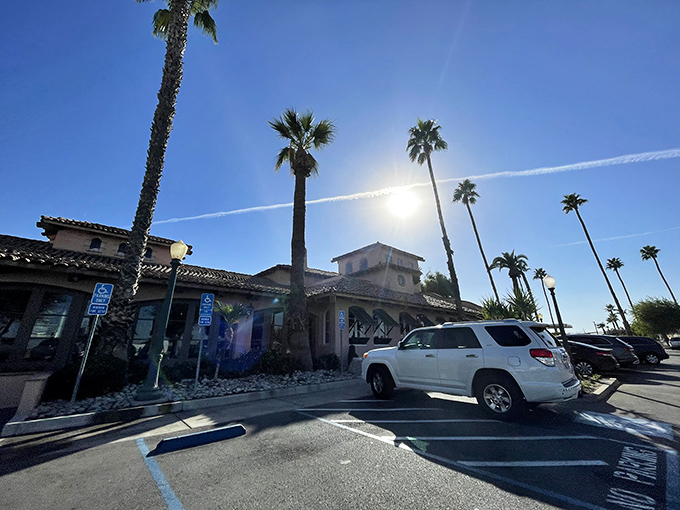 Palm trees frame the entrance to Harris Ranch's Restaurant, where Central Valley dining meets resort ambiance without coastal price inflation.