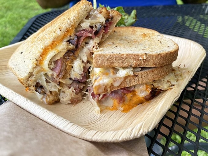 Behold the Reuben in its natural habitat—layers of pastrami, sauerkraut, and melted cheese creating the perfect symphony of savory satisfaction.