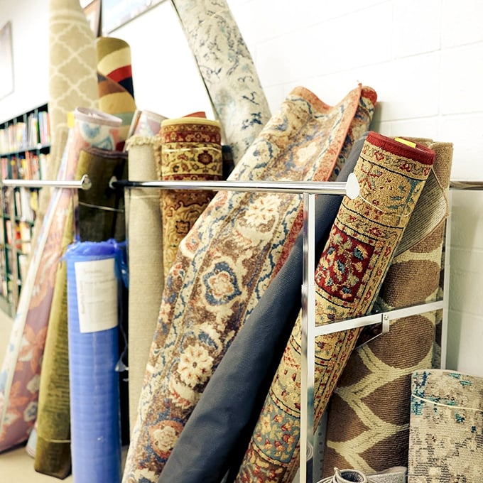 A textile lover's dream—rolled area rugs in intricate patterns await the perfect space, proving luxury floor coverings don't require luxury budgets.