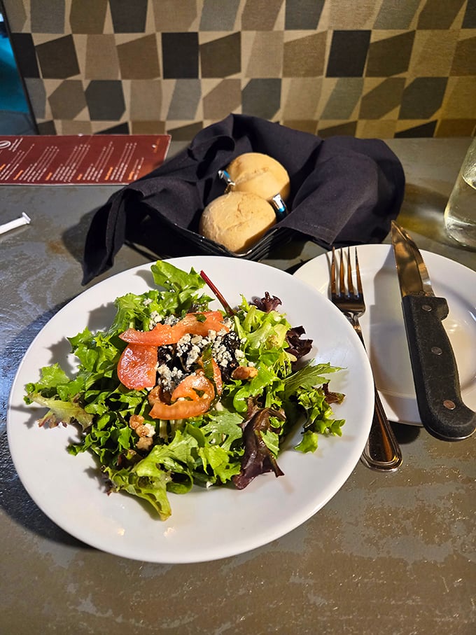 A salad that doesn't apologize for being healthy—fresh greens playing the perfect opening act before the meaty main event arrives.