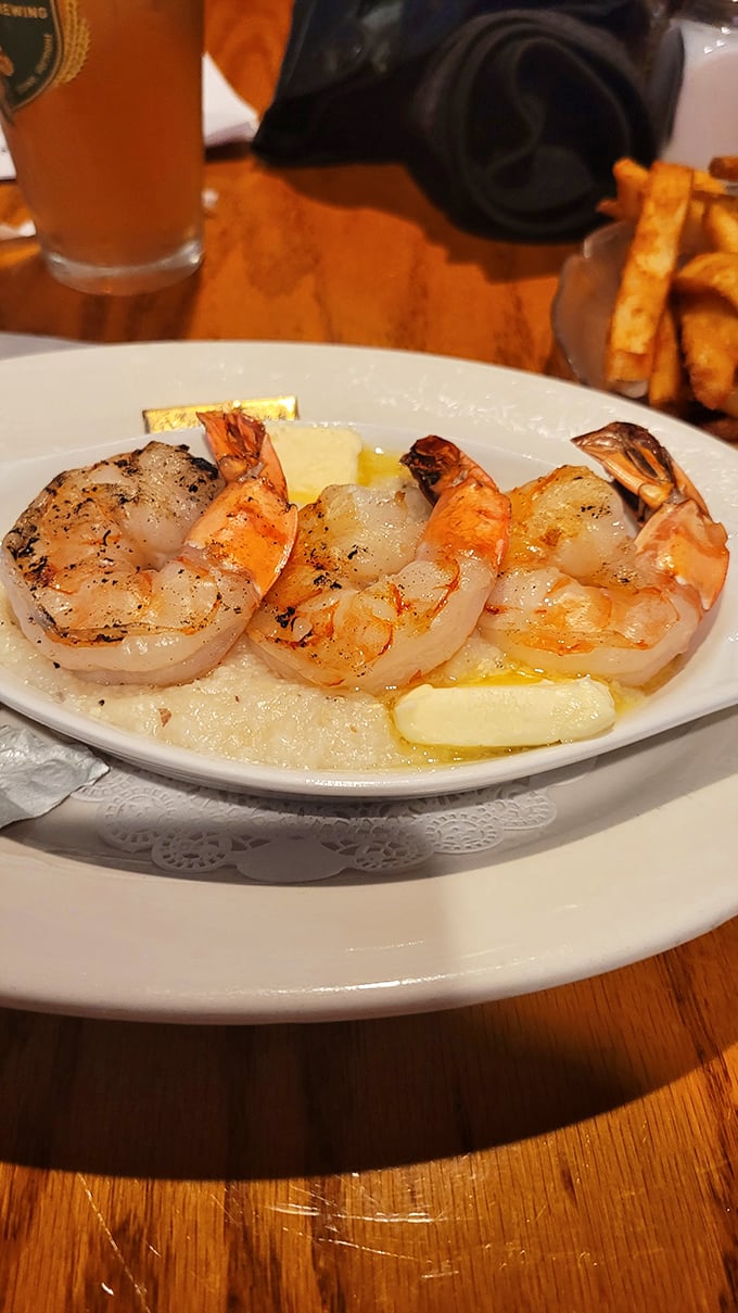 Plump, perfectly grilled shrimp resting in a buttery pool – proof that sometimes the simplest preparations create the most profound flavors.