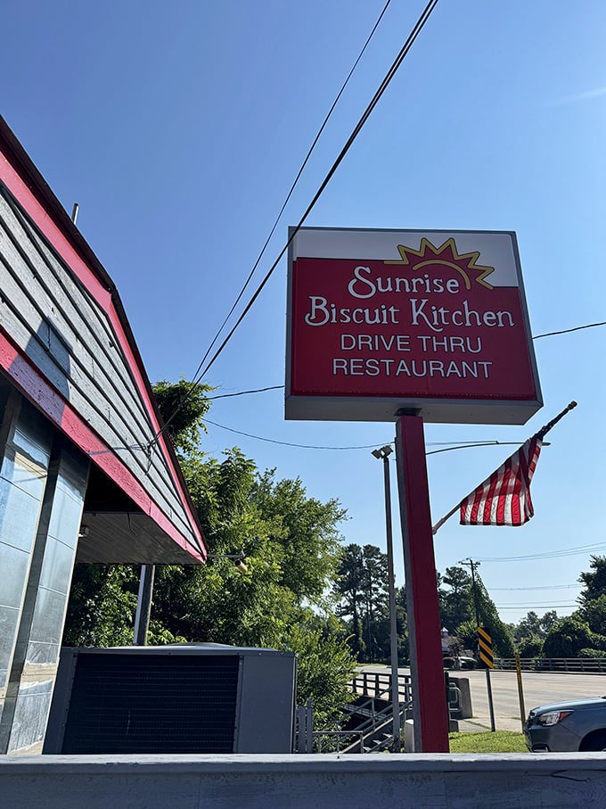 Morning sunshine and an American flag frame the classic Sunrise Biscuit Kitchen sign – a patriotic tribute to one of America's truly perfect breakfast institutions.