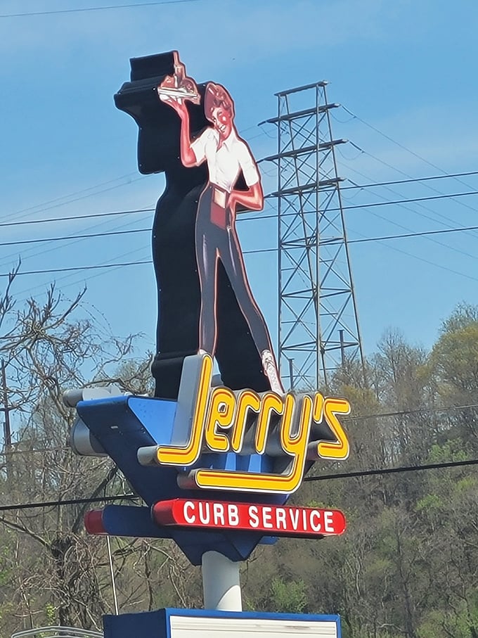 The vintage sign stands tall—a mid-century masterpiece announcing that yes, there is still joy in this world, and it comes with curb service.