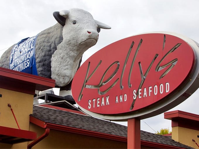 That giant bull on the roof isn't just a quirky landmark—it's a promise of serious steak business happening inside Kelly's distinctive red and tan building.