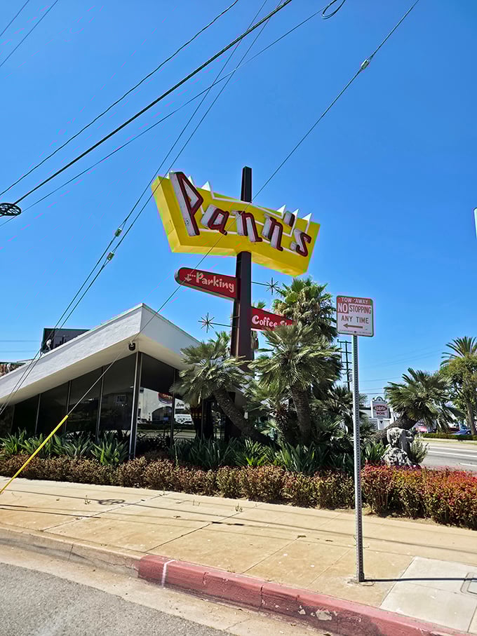 That angular yellow sign against the blue California sky—a beacon of hope for hungry travelers and a landmark for locals in the know.