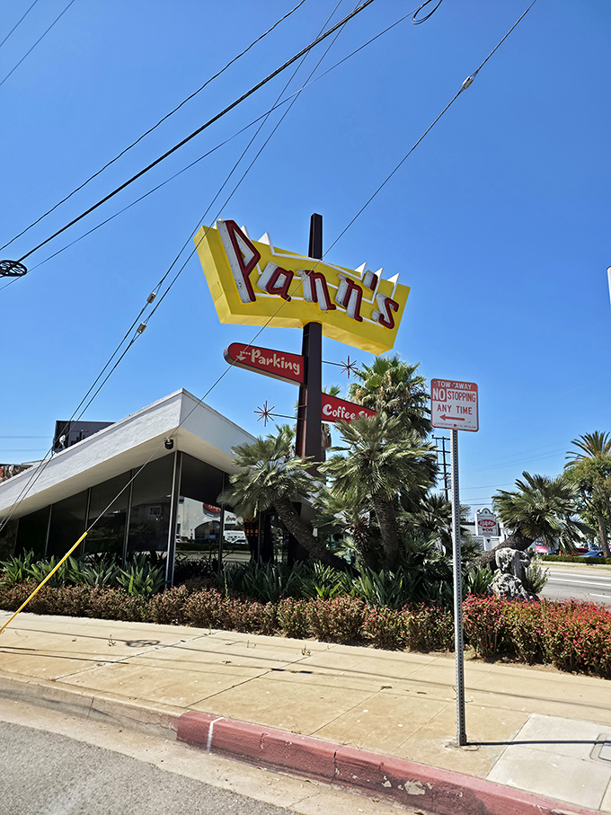 That angular yellow sign against the blue California sky—a beacon of hope for hungry travelers and a landmark for locals in the know.