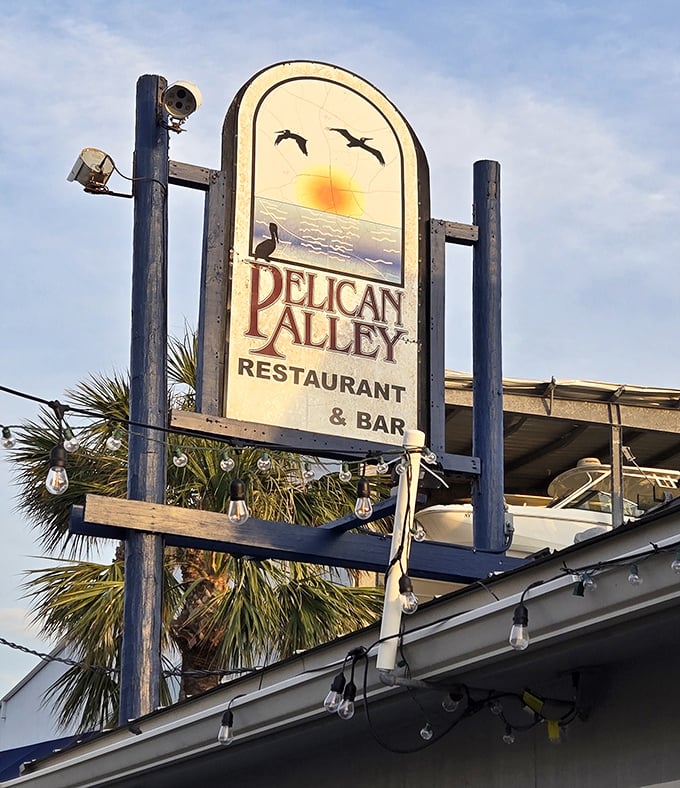 The sign says it all—pelicans, sunset, and promises of good food. This weathered wooden welcome has guided hungry travelers for years.
