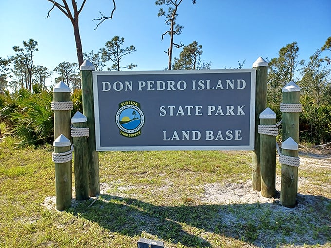The entrance sign stands as a humble gatekeeper to an extraordinary world. No flashing lights needed when natural wonders await.