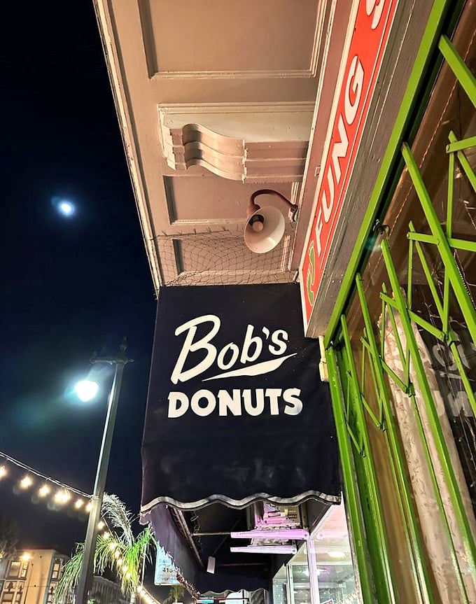 Under moonlight, Bob's sign glows like a beacon for night owls and early risers alike – a 24-hour promise of deep-fried happiness.