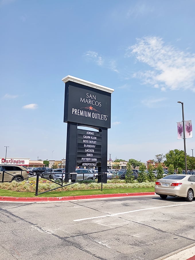 The marquee that launches a thousand shopping sprees – San Marcos Premium Outlets sign standing tall, a beacon to bargain hunters across the Lone Star State.