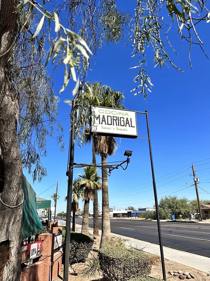 The Cocina Madrigal sign against that impossibly blue Arizona sky. Like a beacon guiding hungry travelers to their flavor destination.