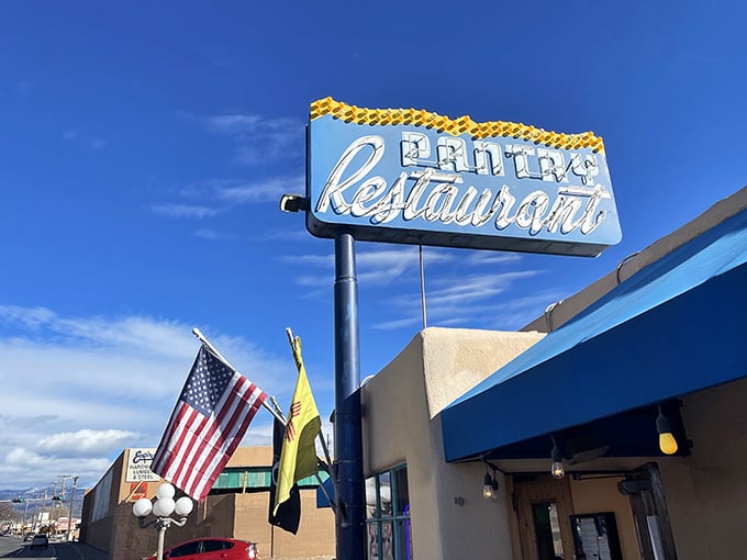 That retro sign against New Mexico's impossibly blue sky is better than any five-star rating. The fluttering flags are just saying what we're all thinking: "Come eat here now."
