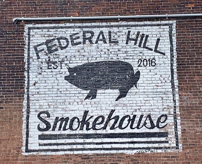 The iconic pig sign painted on brick—a beacon of hope for the hungry and a landmark for barbecue believers everywhere.