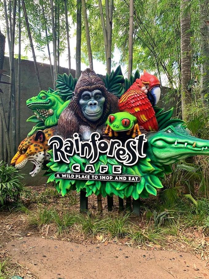 The colorful menagerie of animals on the Rainforest Cafe sign promises exactly what it delivers – "A Wild Place to Shop and Eat."
