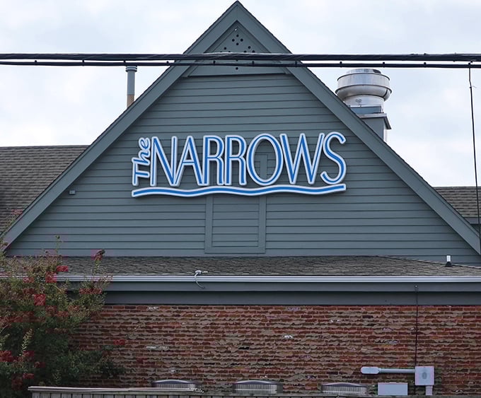 That neon sign doesn't just mark a restaurant—it's a beacon guiding hungry travelers to crab cake nirvana. The brick below has heard thousands of "best meal ever" declarations.