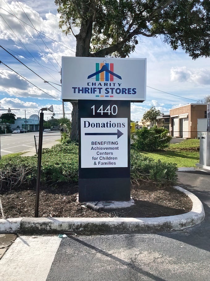 The roadside sign announces your arrival at the promised land of secondhand treasures, benefiting local children and families with every purchase.