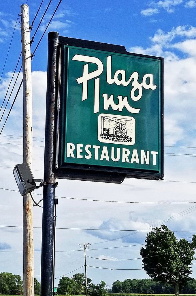 The iconic green sign stands as a beacon for hungry travelers. Like a lighthouse, but guiding you to meatloaf instead of safety.