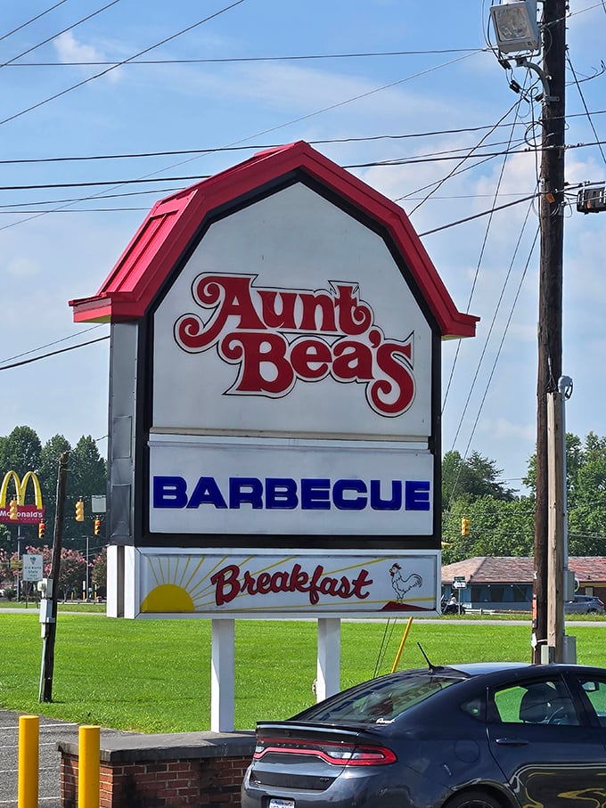 That distinctive barn-shaped sign stands tall – a barbecue lighthouse guiding hungry travelers home to flavor country.