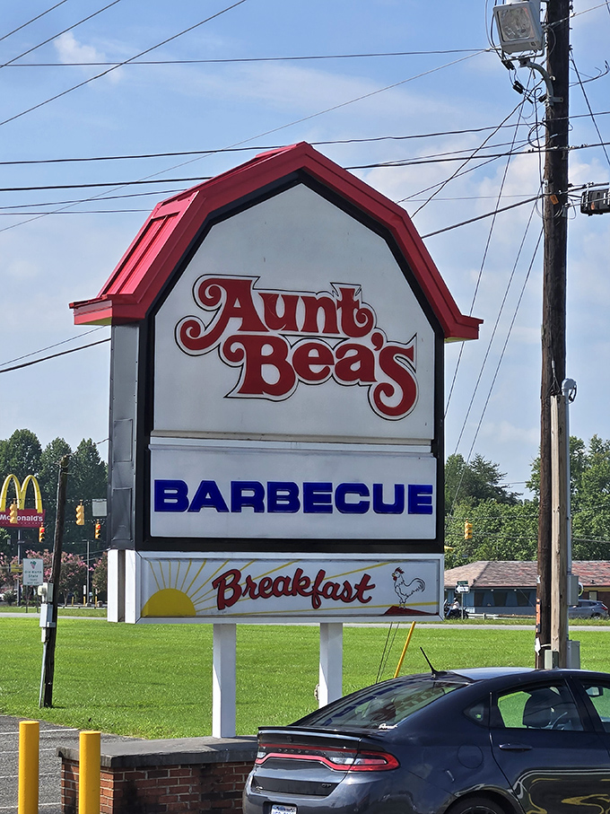 That distinctive barn-shaped sign stands tall – a barbecue lighthouse guiding hungry travelers home to flavor country.