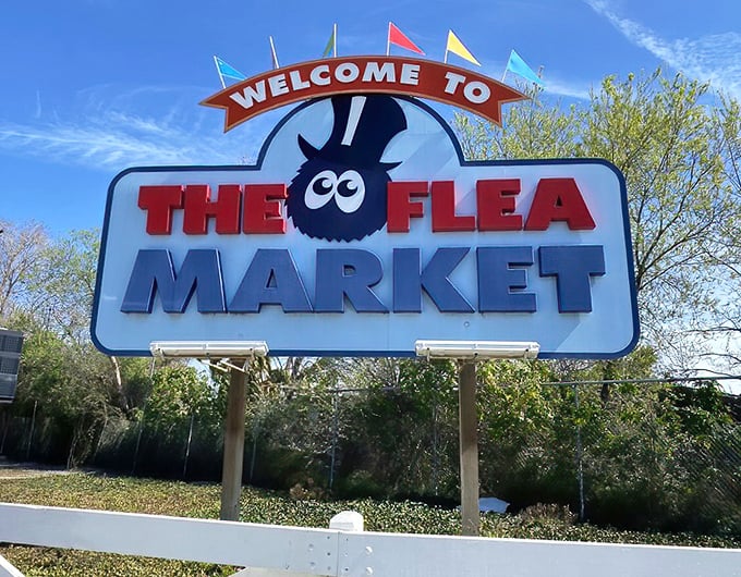 The iconic flea mascot welcomes visitors to California's most entertaining shopping adventure with infectious enthusiasm.