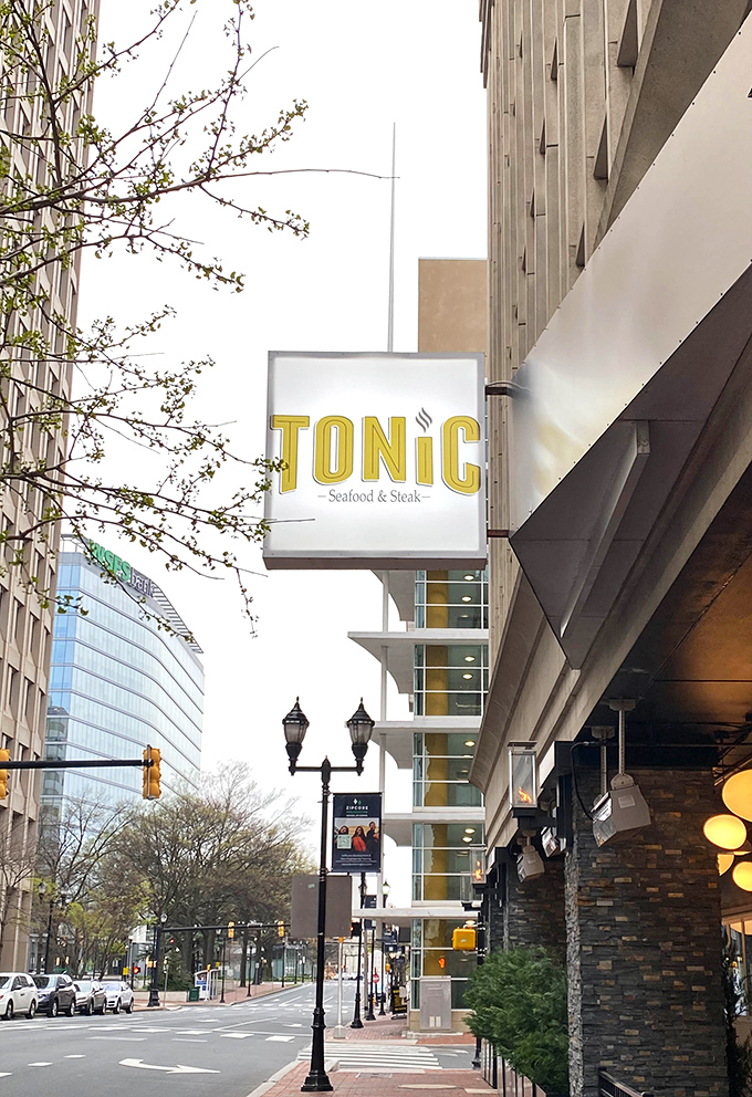 The Tonic sign stands as a beacon of culinary promise amid Wilmington's business district – like finding an oasis in a desert of office buildings.